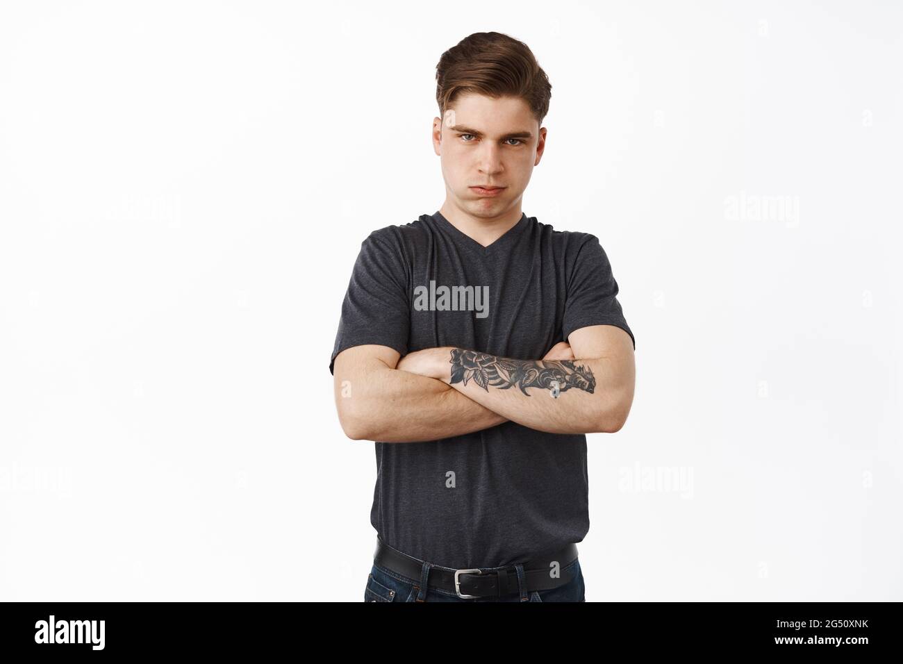 Angry and displeased young man feel offended, cross arms on chest ...