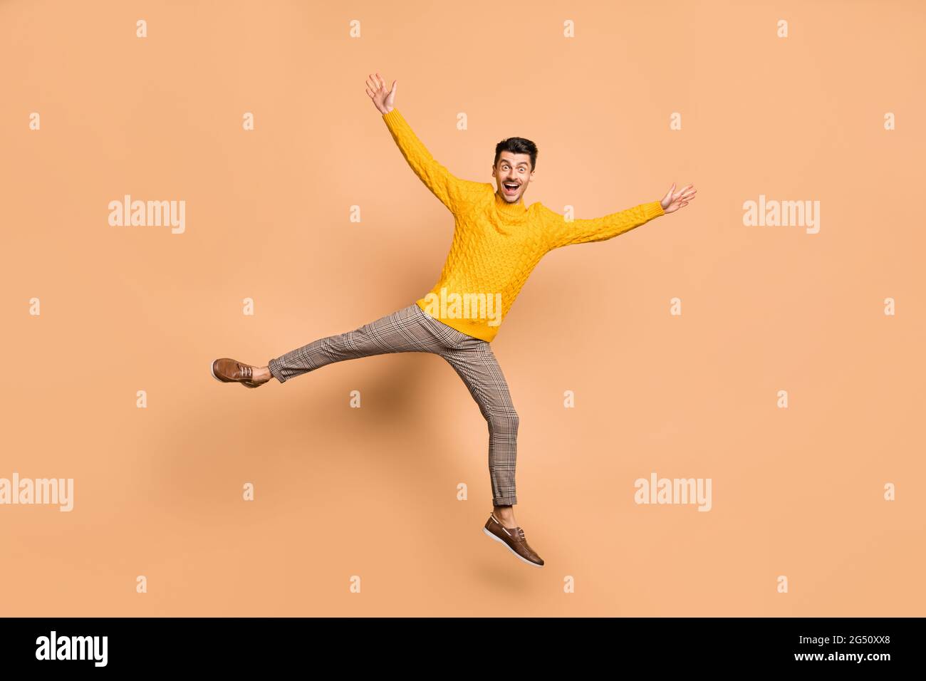 Full length photo portrait of excited guy spreading arms legs like star ...