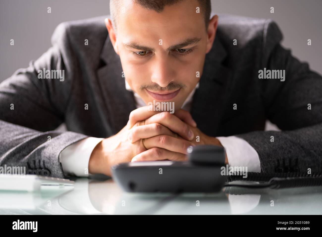 Waiting For Phone Call On Office Landline At Desk Stock Photo - Alamy