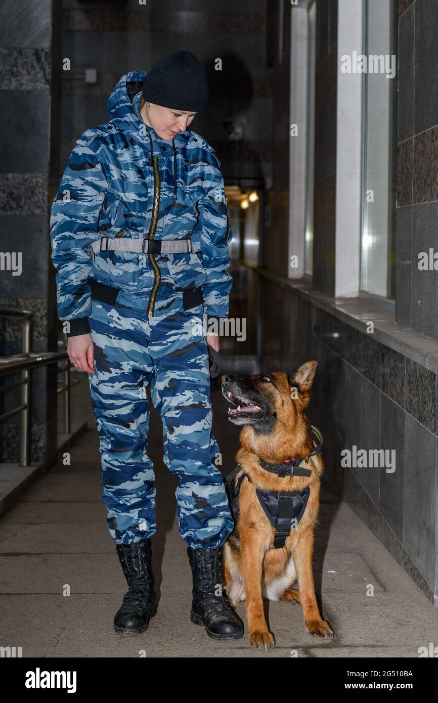 Female police officers with a trained dog. German shepherd police dog ...