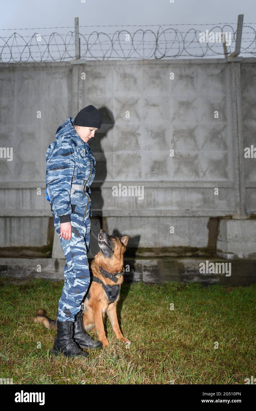 Female police officers with a trained dog. German shepherd police dog ...