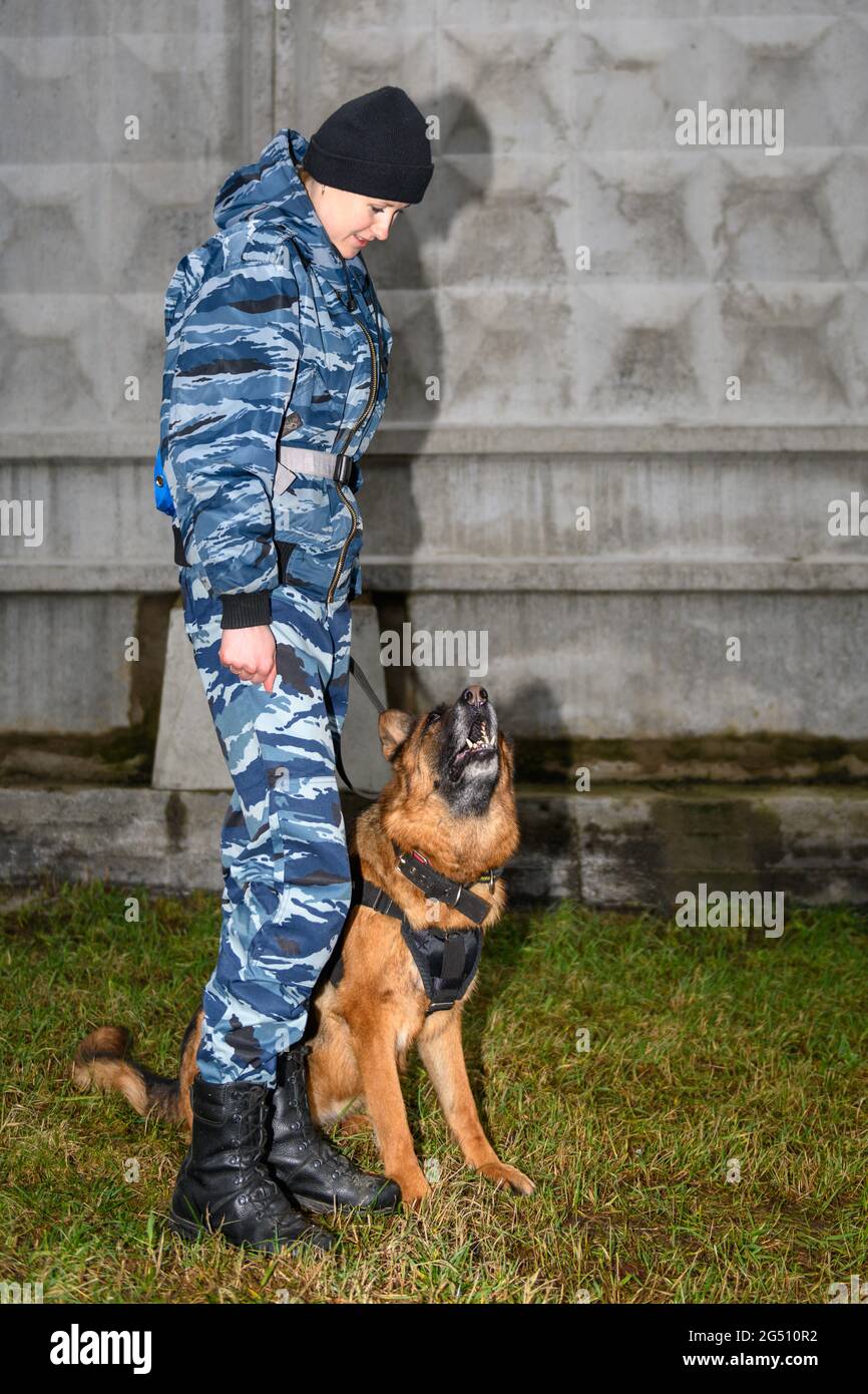Female police officers with a trained dog. German shepherd police dog ...