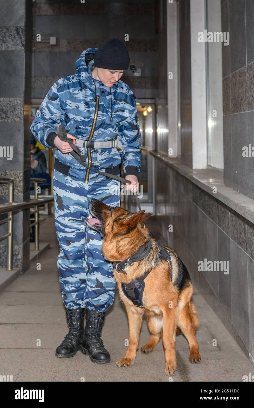 Female police officers with a trained dog. German shepherd police dog ...