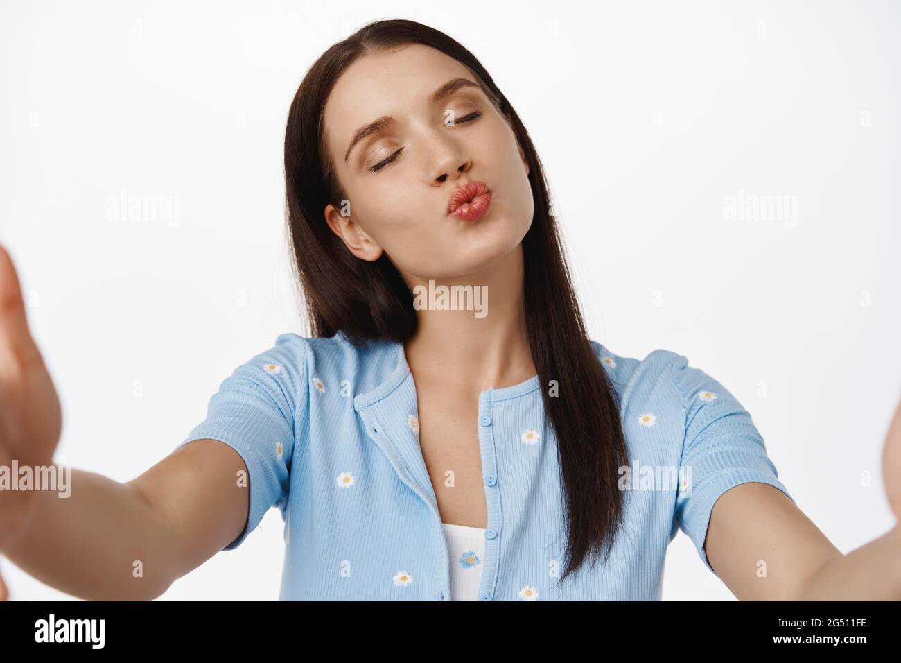 Young woman holding camera, smartphone or tablet, video calling with ...