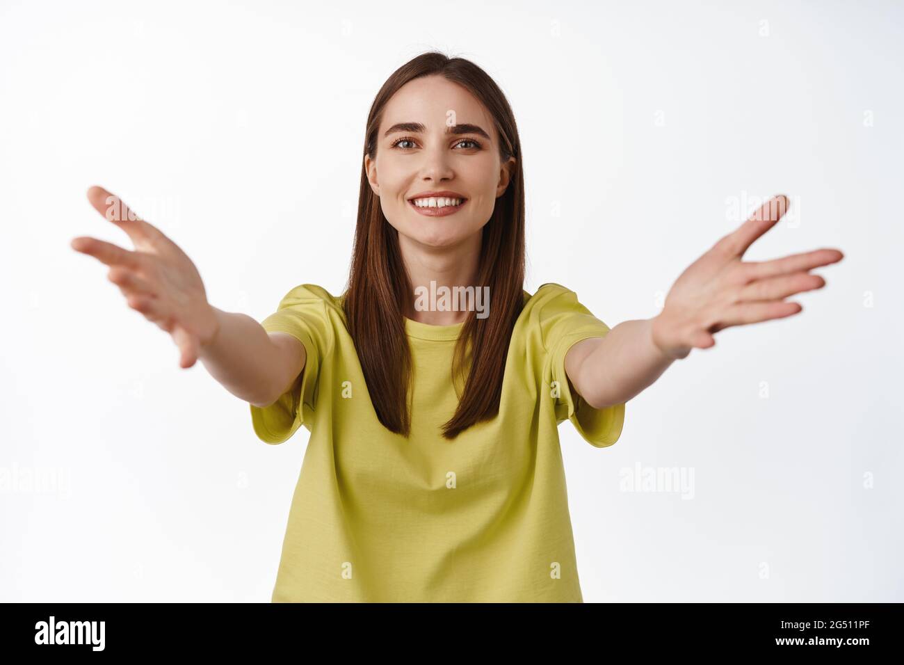 Welcome. Smiling friendly girl reaching for hugs, spread hands to hold ...