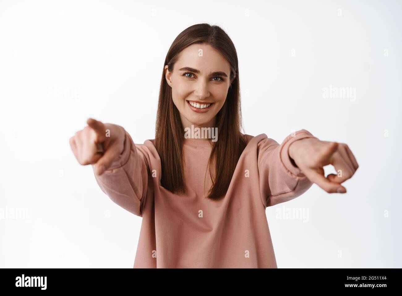 We need you. Smiling brunette woman pointing fingers at camera ...