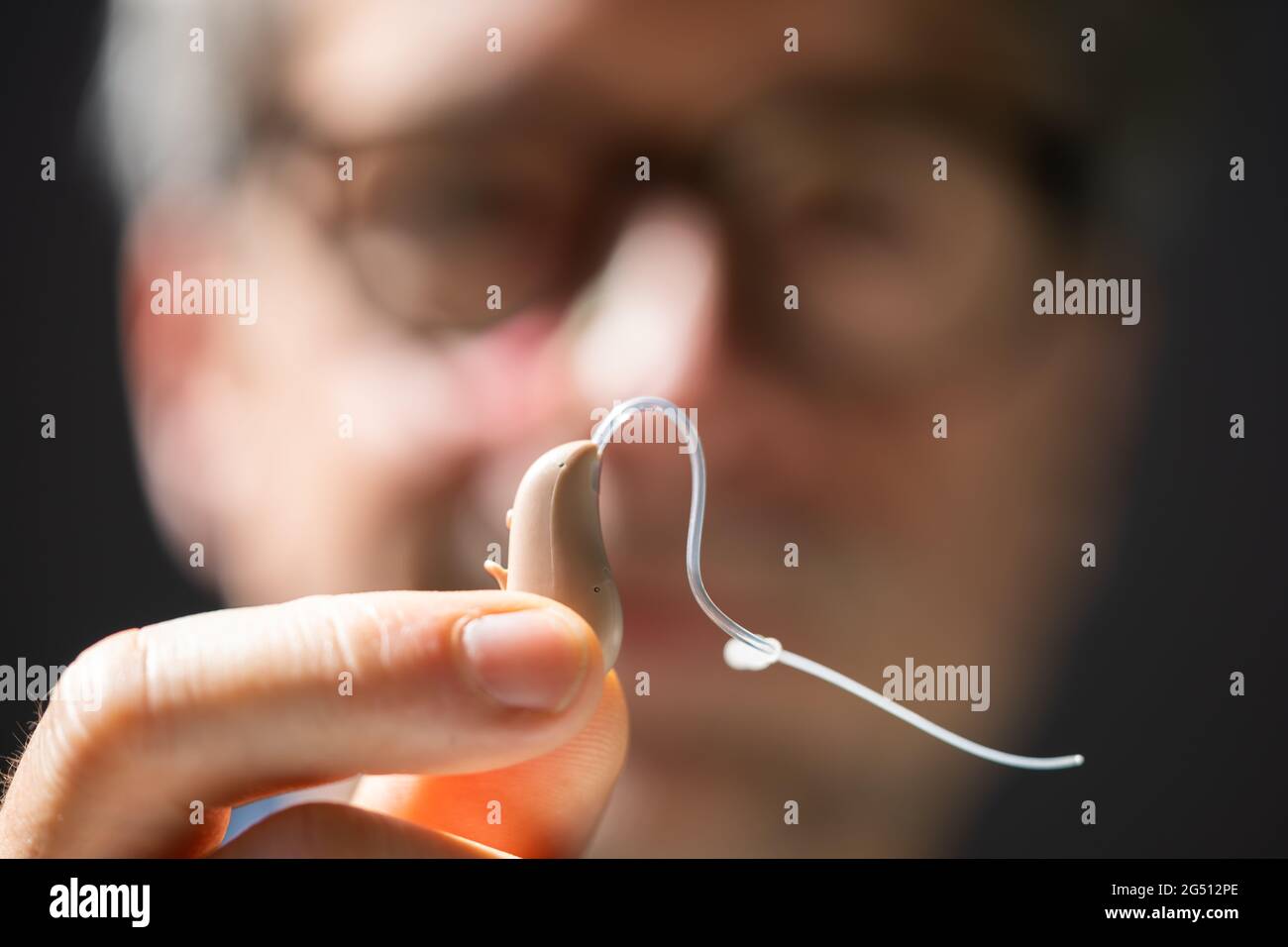 Hearing Aid For Deaf Handicapped Man. Ear Audiology Stock Photo - Alamy