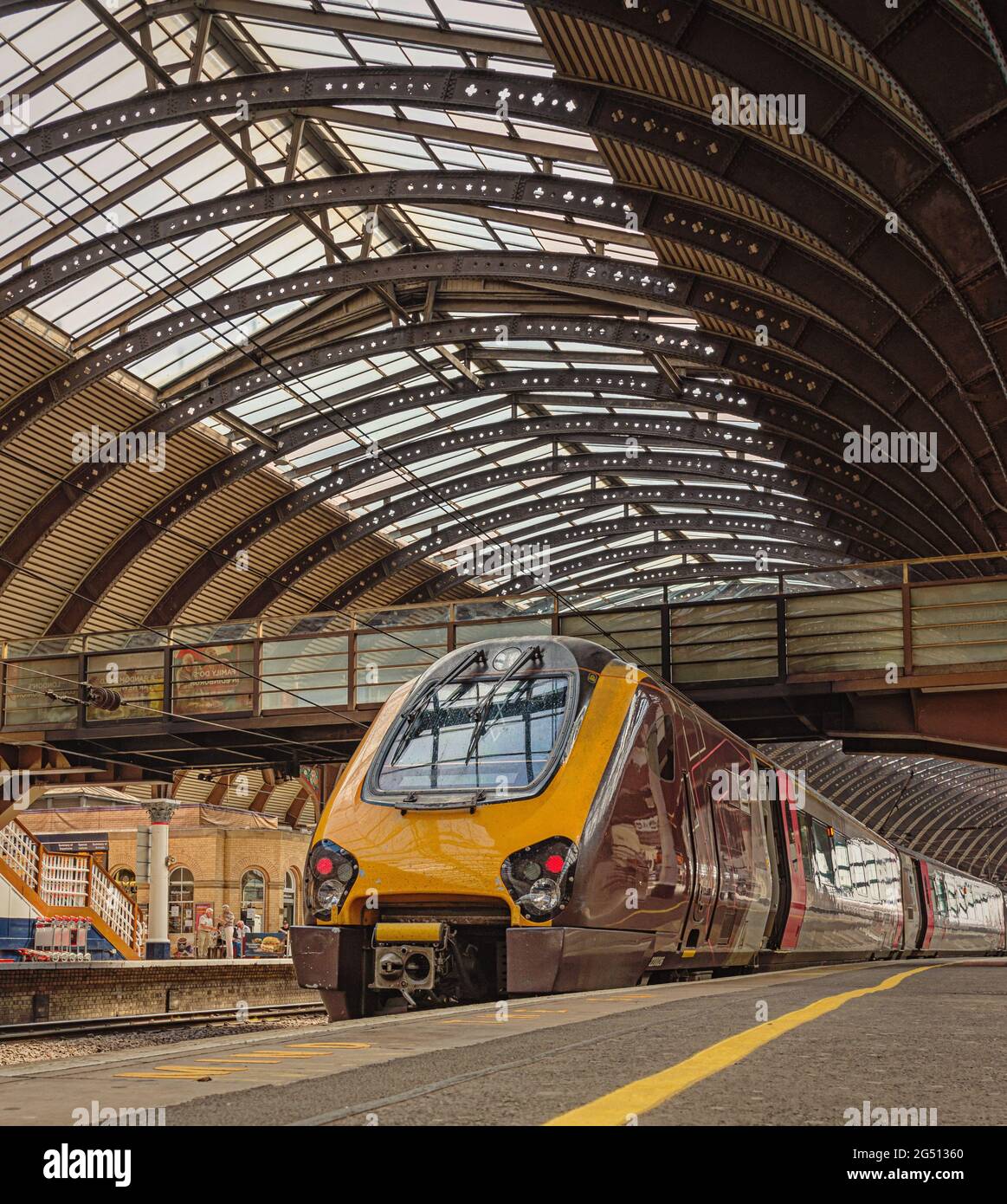 A long-angle view of train standing at a platform of a railway station ...