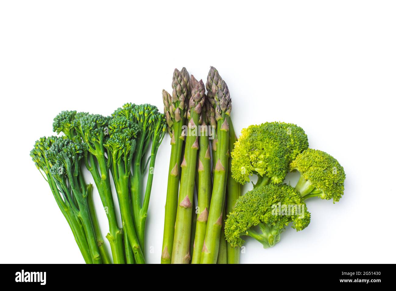 Raw broccolini at the row on white background Stock Photo - Alamy