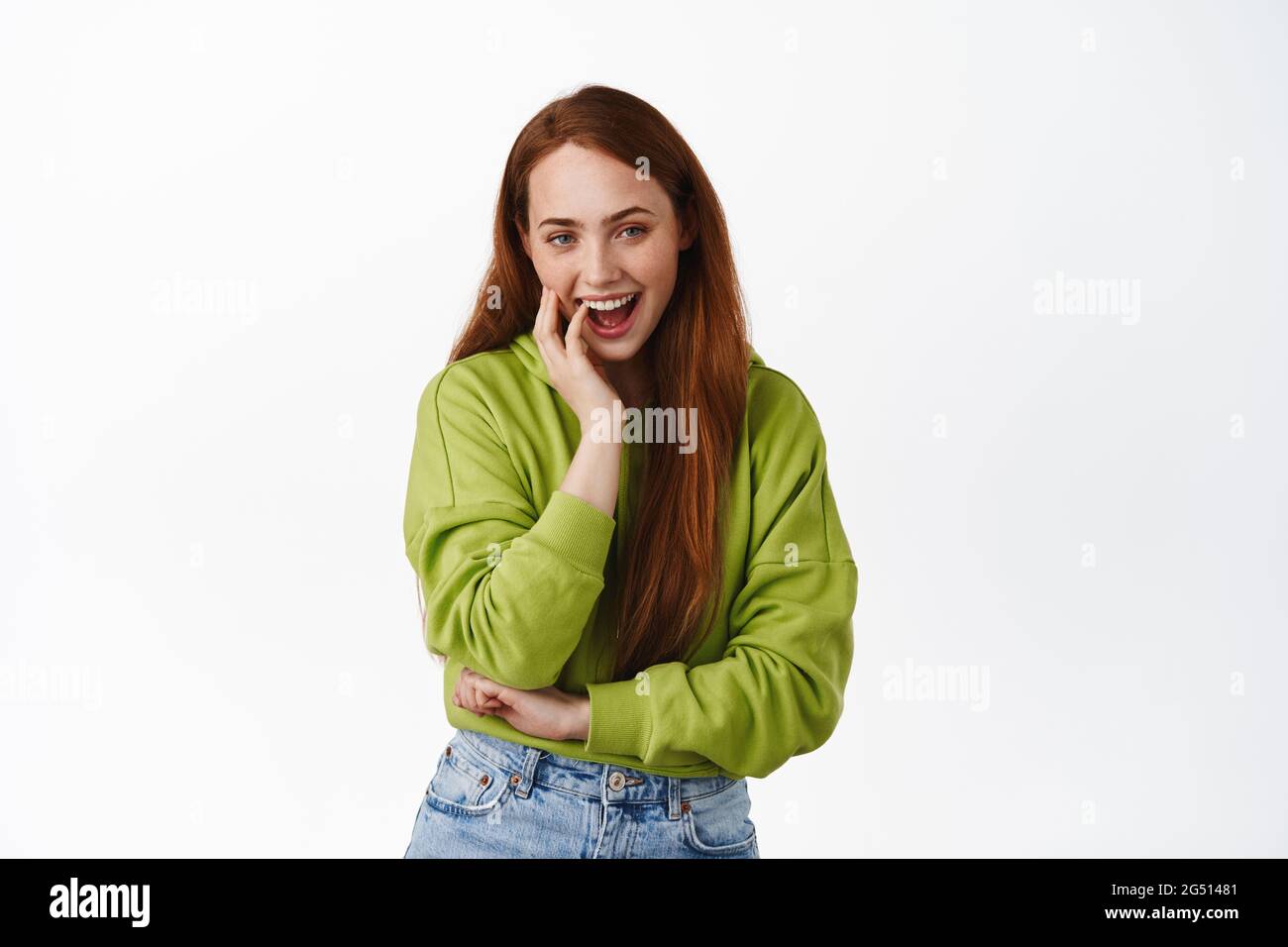 Stylish redhead woman laughing, smiling and looking amused at camera ...