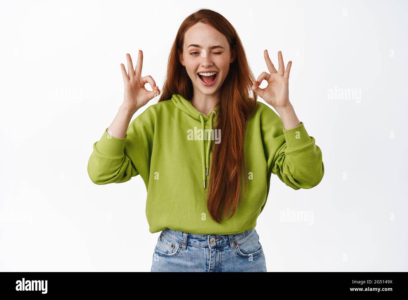 Smiling ginger girl laughing, showing okay OK signs and look happy ...