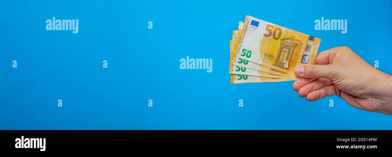 Money in hand, poster with banknote in hand. Hand holding 50 euro ...