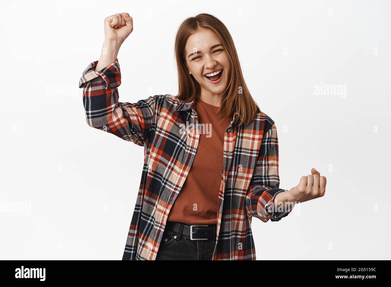Yes celebrating. Cheerful young woman achieve goal success, scream from ...