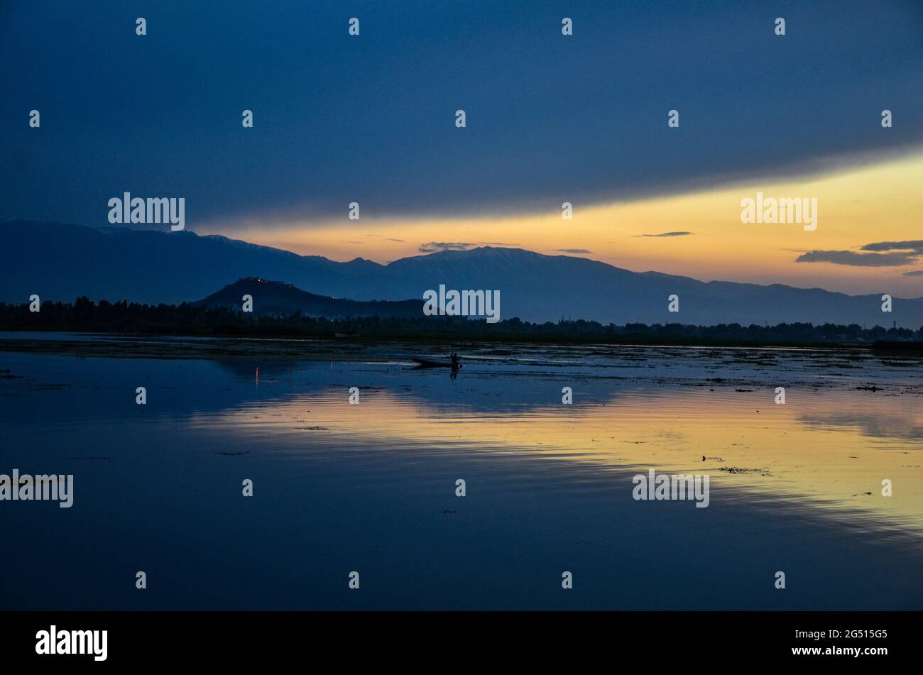Srinagar, India. 24th June, 2021. A boatman rows his boat along Dal ...