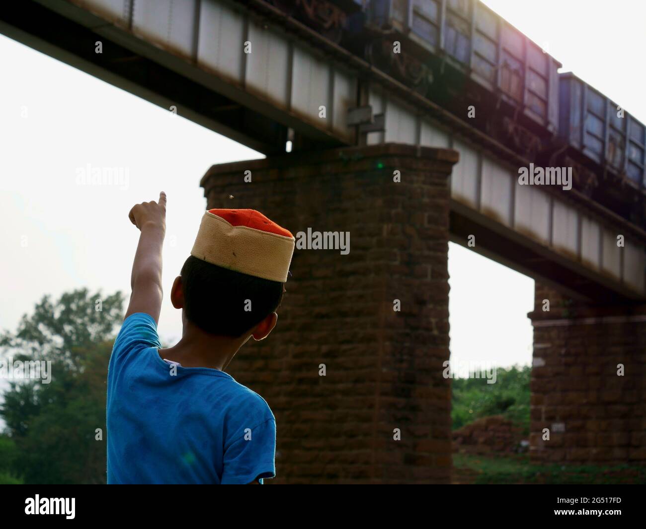 Muslim boy pointing finger towards train on blur background Stock Photo ...