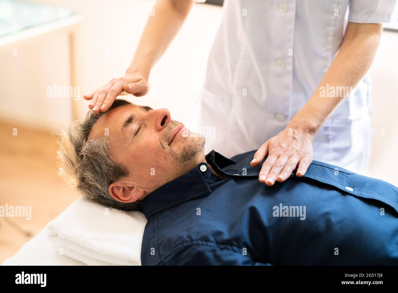 Reiki Therapy Alternative Healing Massage For Man Stock Photo - Alamy
