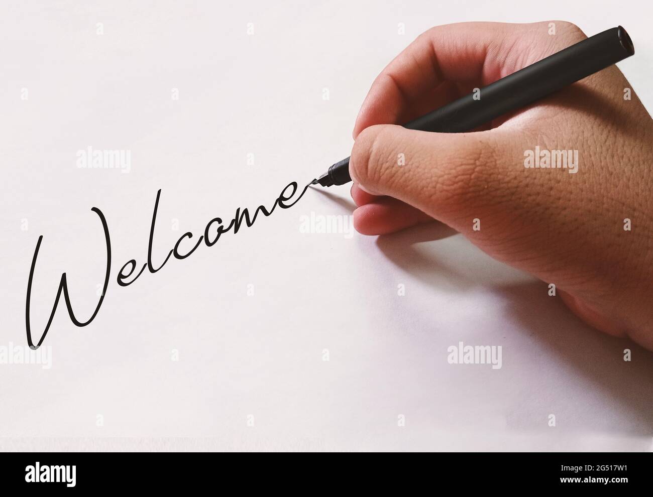 Welcome Message Writing with Hand on a White Black Paper. Modern ...