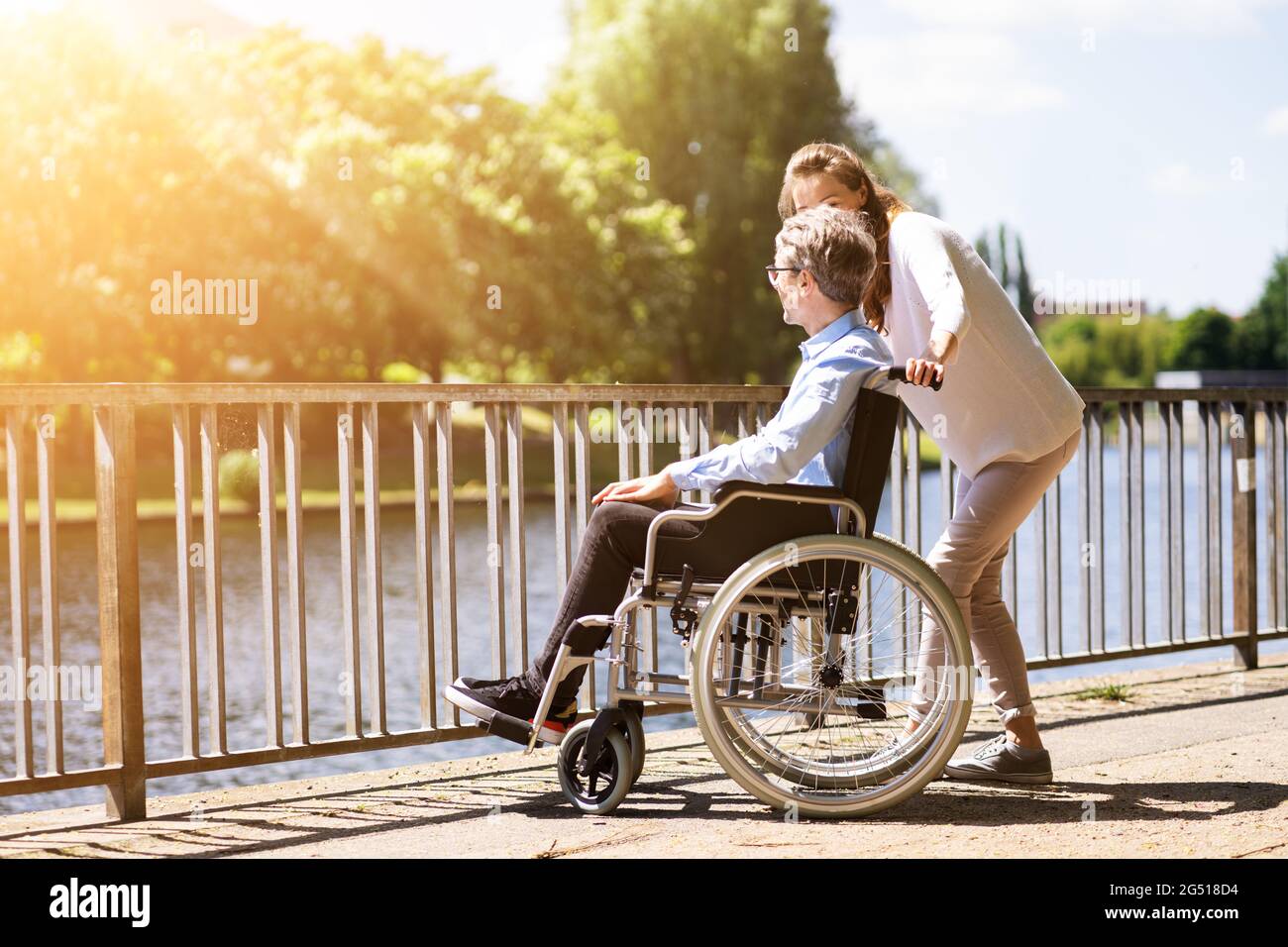 Senior Care And Wheelchair Transport. Smiling Woman Pushing Elderly Man ...