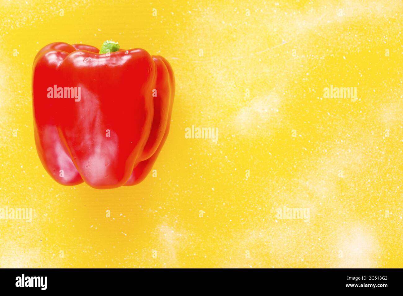 Top view of a red bell pepper isolated on yellow background for a copy ...