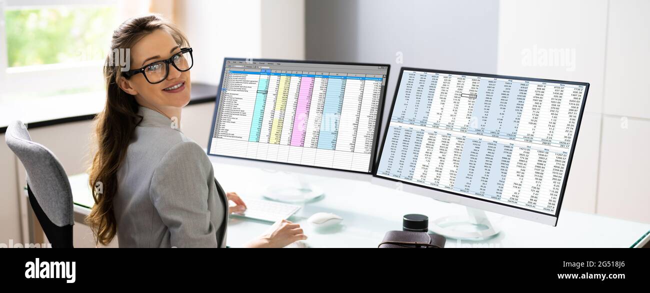 Spreadsheet Analyst Employee Using Computer Monitors For Analysis Stock ...
