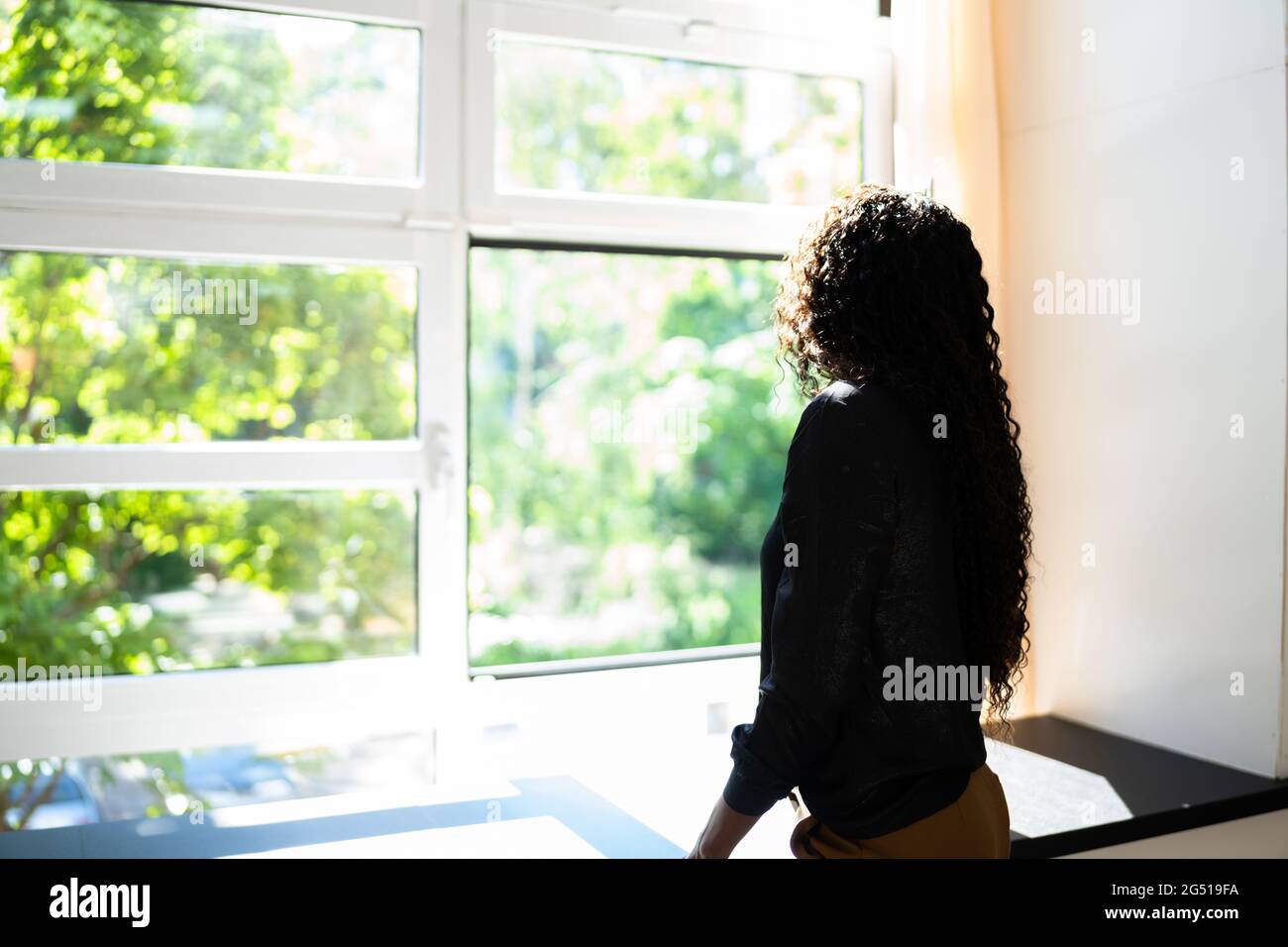 African Woman Opening Window For Fresh Air. Side View Stock Photo - Alamy