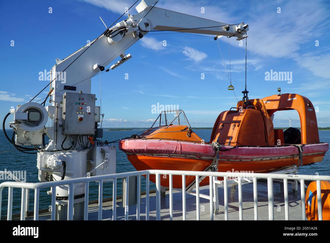 Orange lifeboat, rescue boat of ferry boat sailing on the sea with blue ...