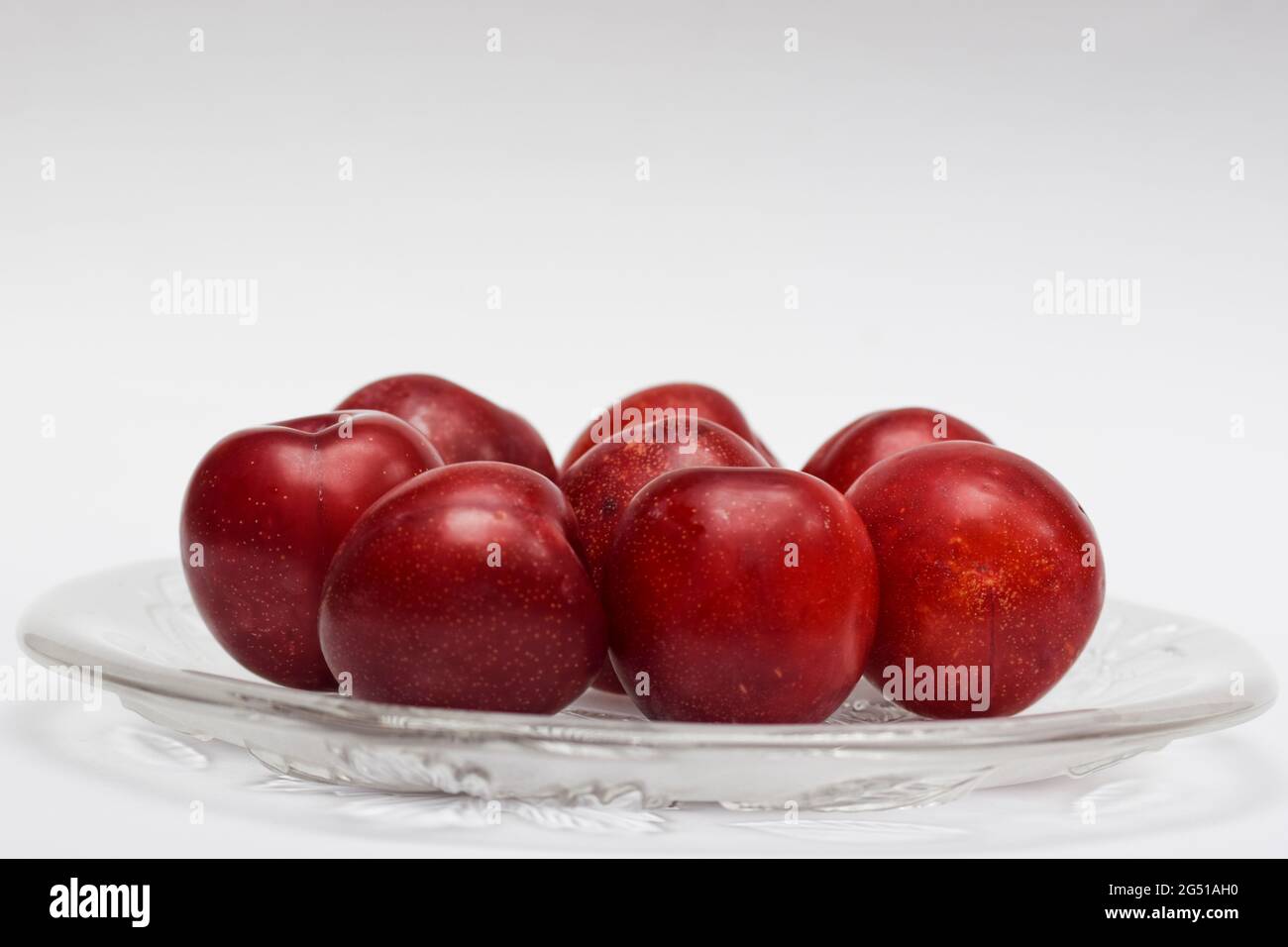 Raw Organic red Plums on white background, red maroon shades, fresh ...