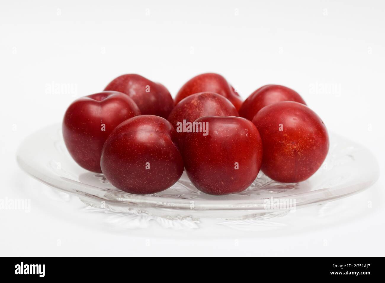 Raw Organic red Plums on white background, red maroon shades, fresh ...
