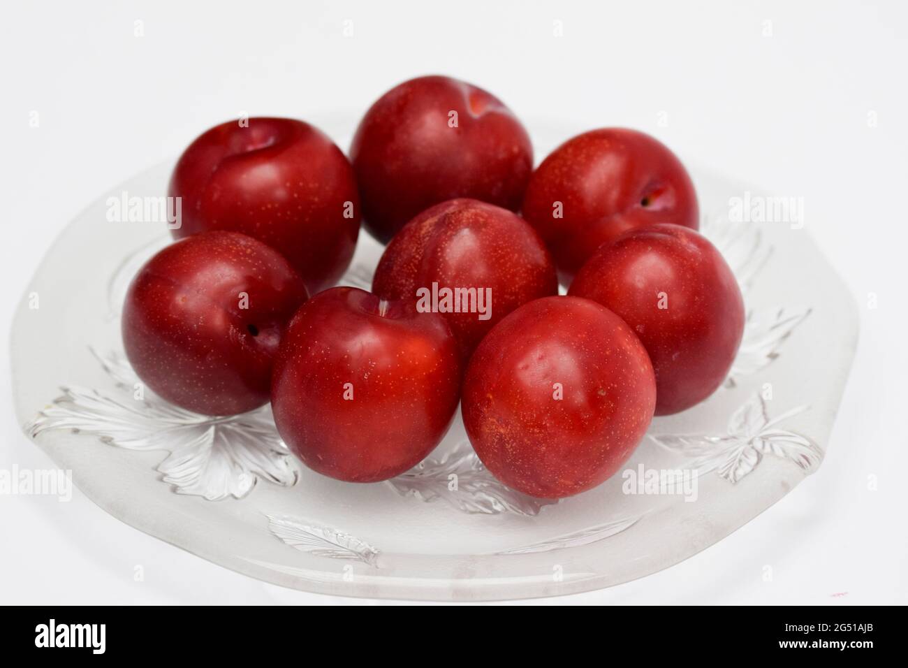 Raw Organic red Plums on white background, red maroon shades, fresh ...