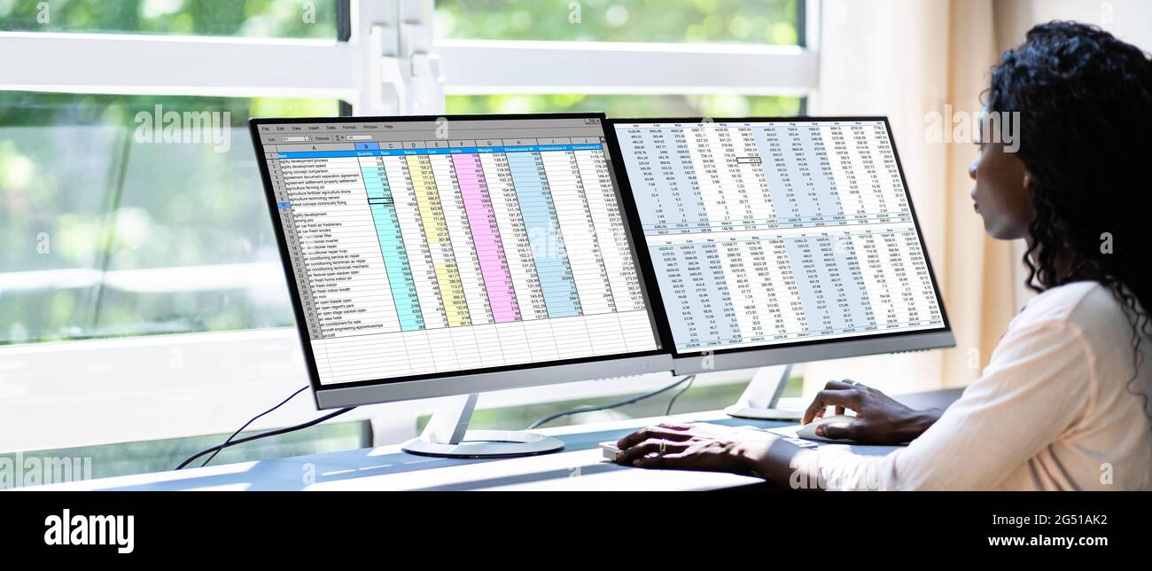 Data Analyst African Woman Using Spreadsheet On Computer Stock Photo ...