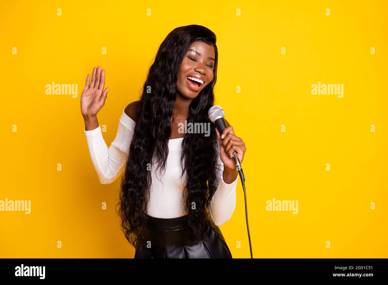 Photo portrait of dreamy smiling woman singing karaoke keeping ...