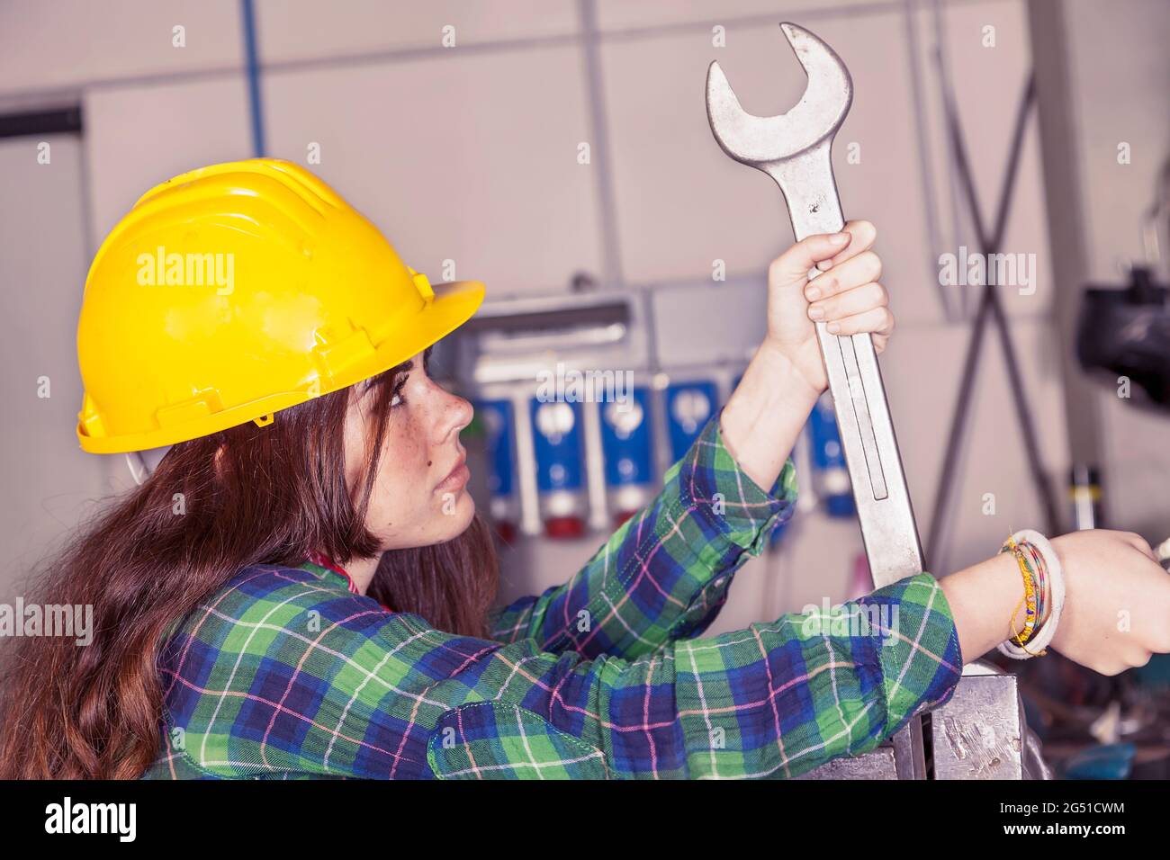 portrait of young female metalworker engaged with wrench Stock Photo ...