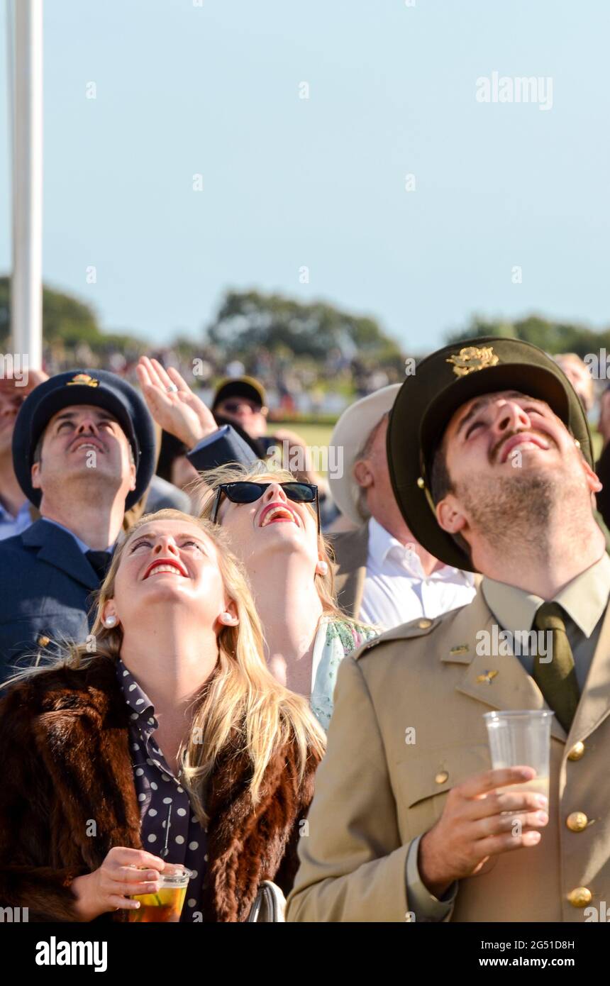 Visitors in period attire looking up watching the flying display at the ...
