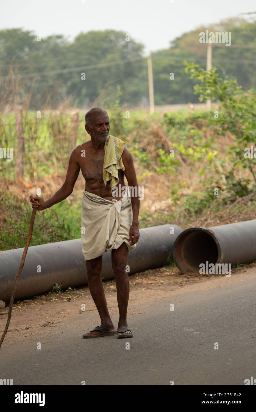 An old man leans on a stick Stock Photo - Alamy