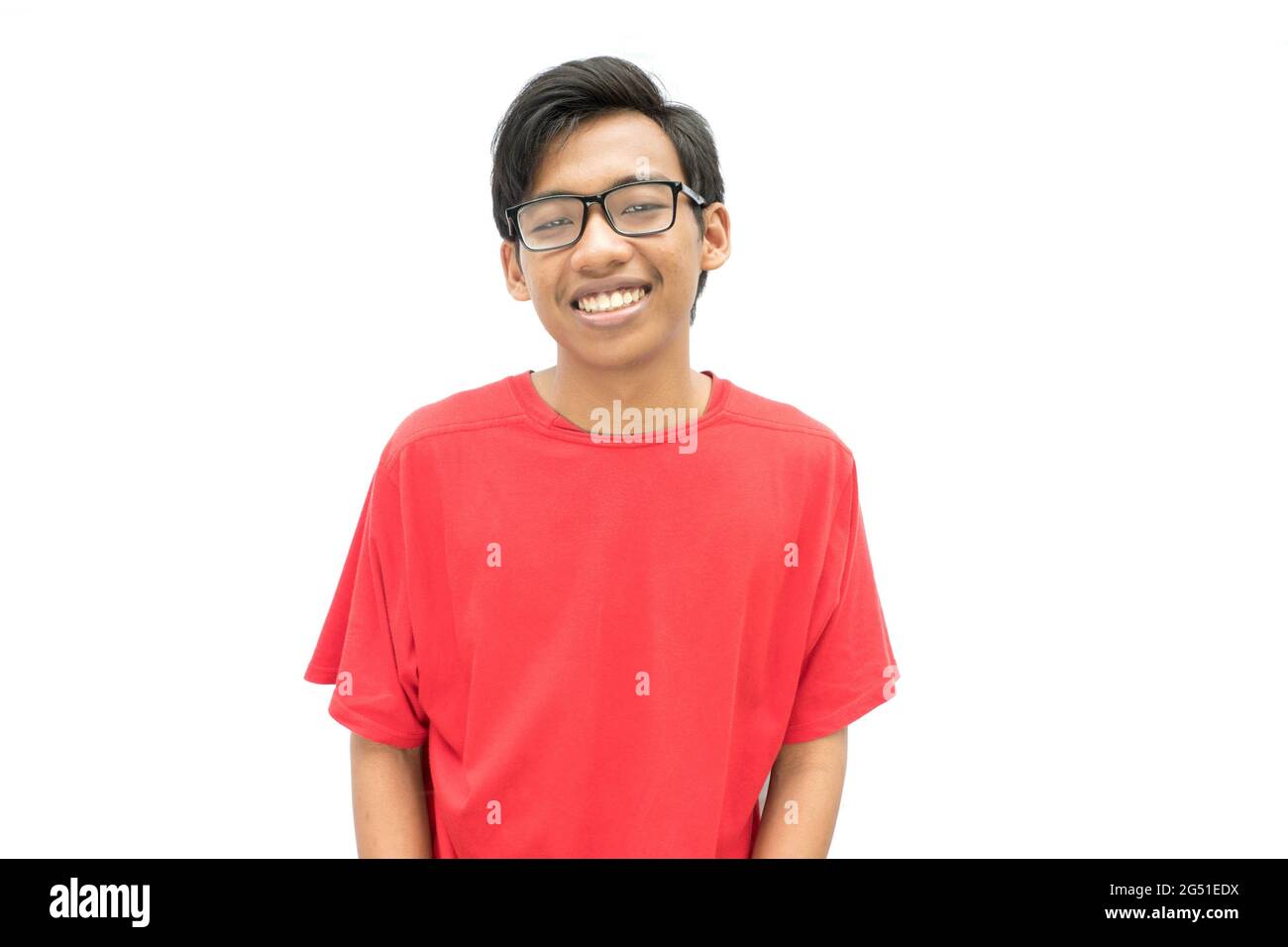 Happy smiling Indonesian guy wearing a red t-shirt and eyeglasses ...