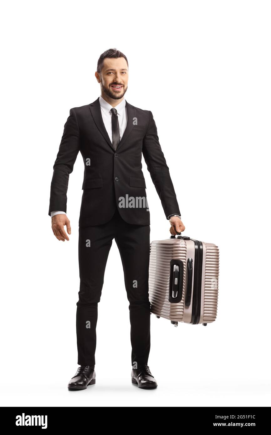 Full length portrait of a man in a suit and tie carrying a suitcase and ...