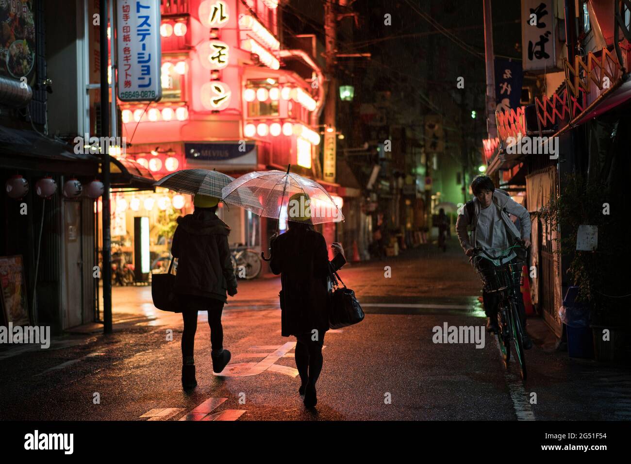 People walking in the rain at night in Osaka, Japan Stock Photo - Alamy