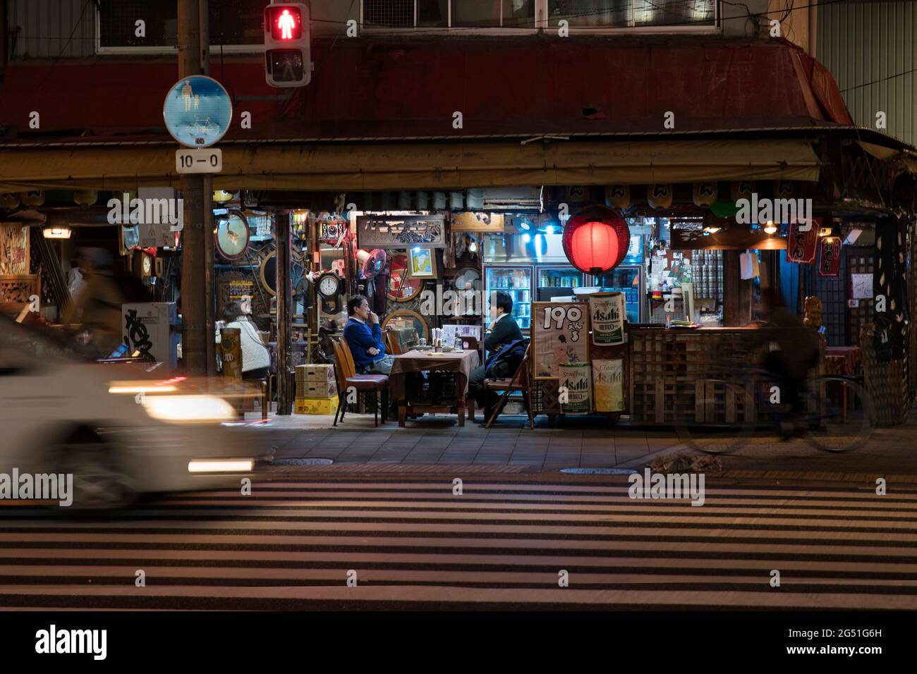 People sitting at a small cafe/bar in Osaka, Japan Stock Photo - Alamy