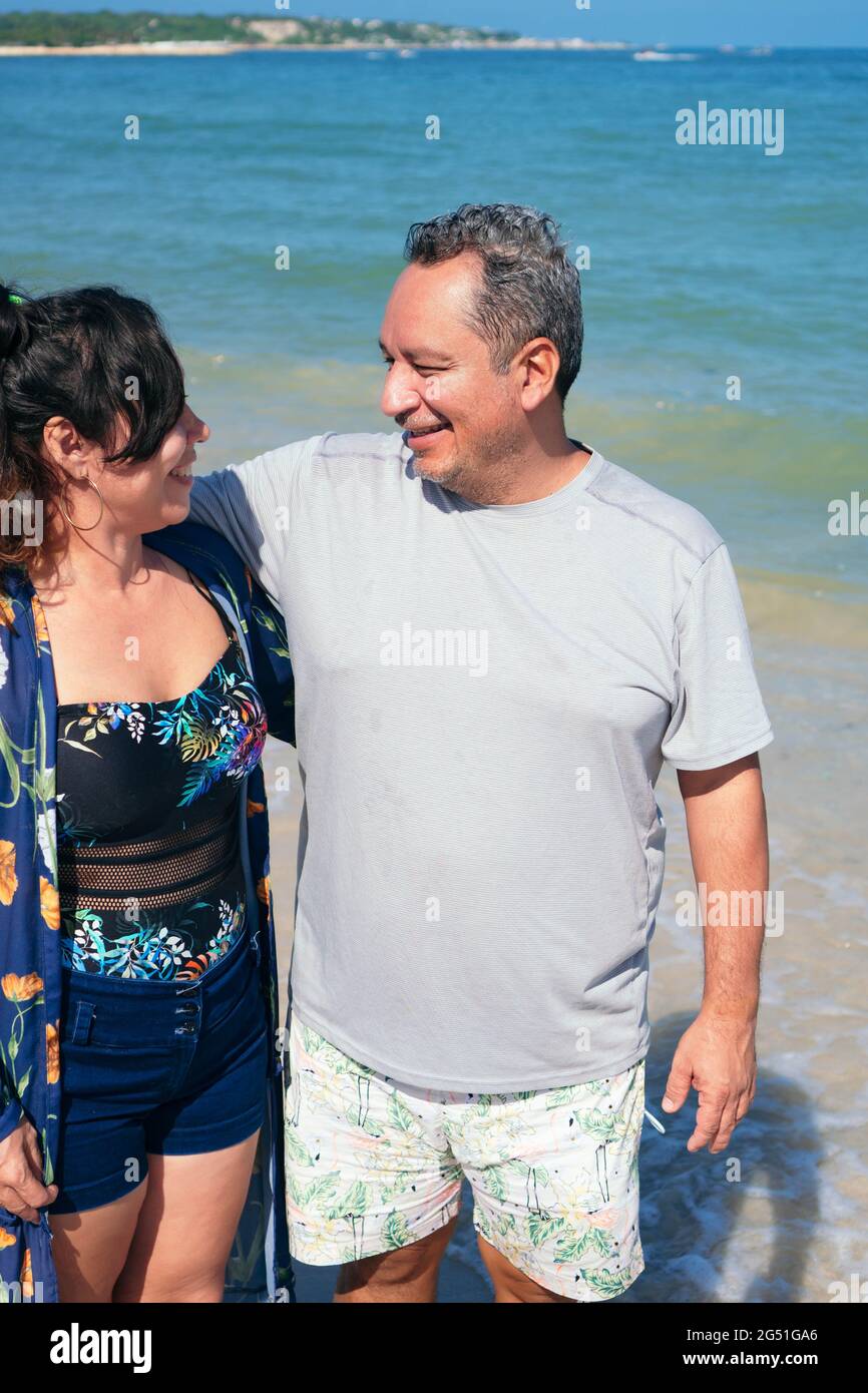 Mature Married Couple Hugging Each Other Standing At The Beach Stock