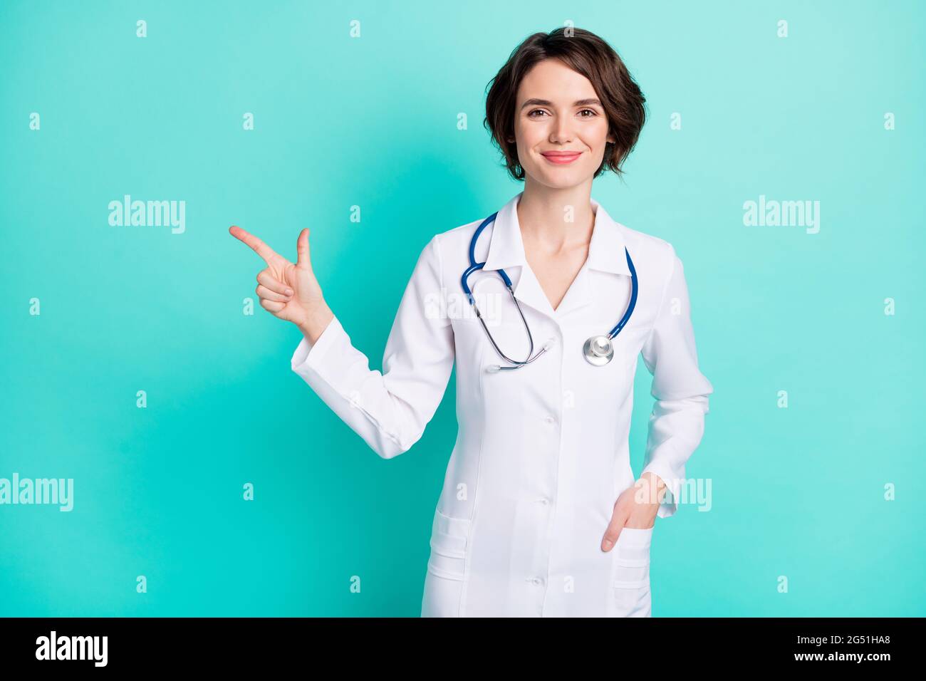 Photo of young woman doctor happy smile indicate finger empty space ...