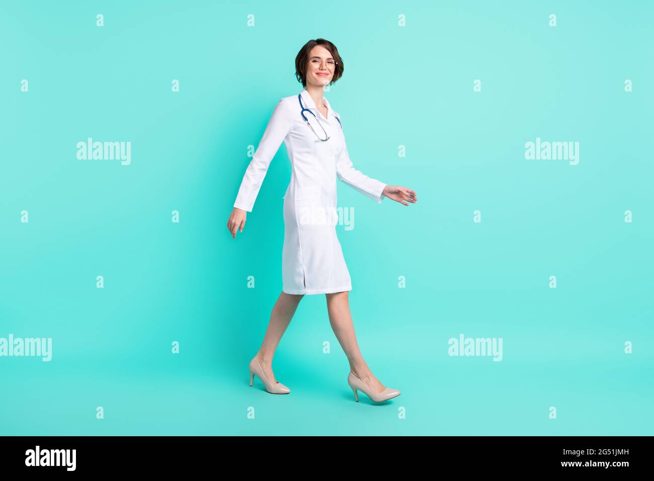 Full length body size side profile photo of nurse smiling going forward ...