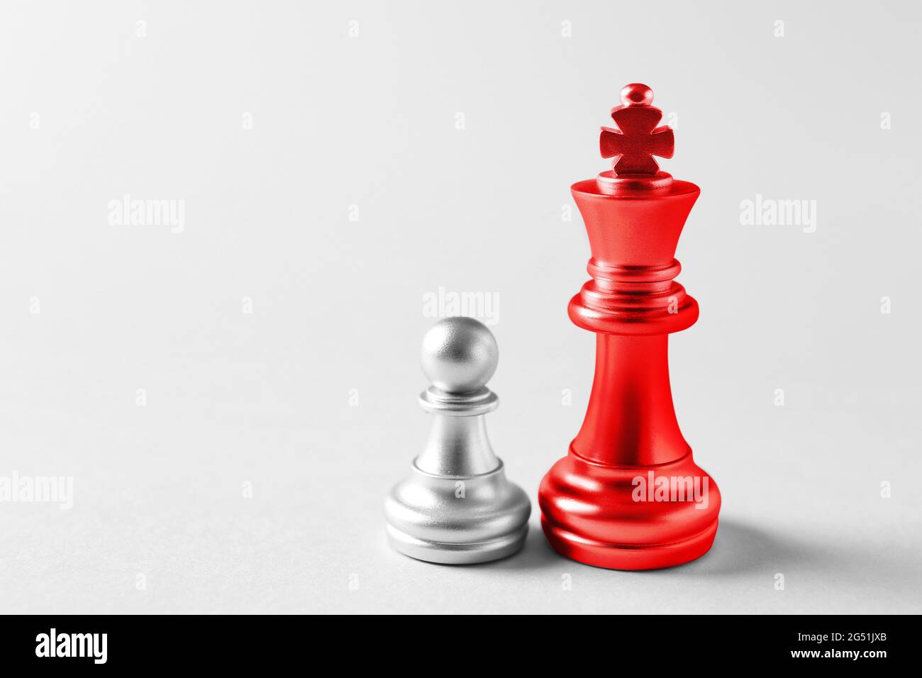 Red king and silver pawn on light background Stock Photo - Alamy