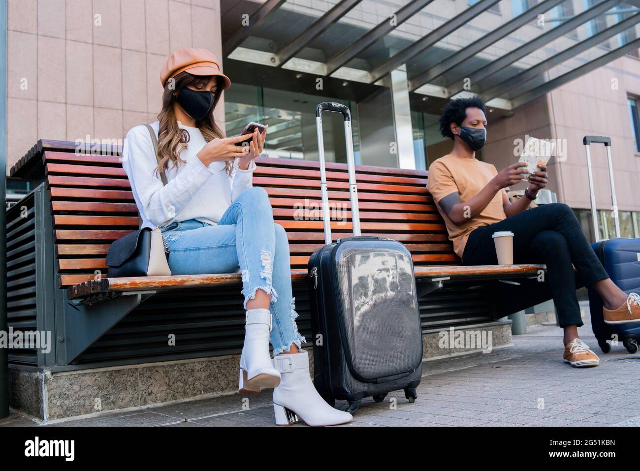 Tourist people waiting outside airport or train station Stock Photo - Alamy