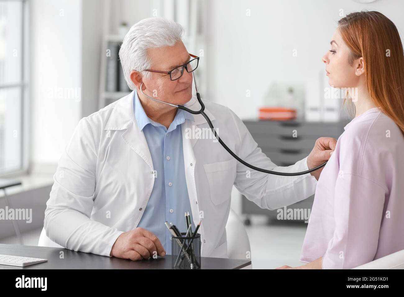 Pulmonologist with stethoscope examining patient in clinic Stock Photo ...