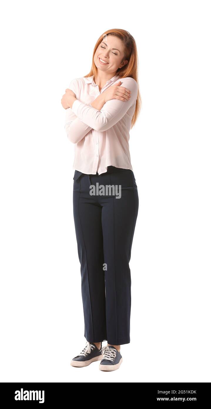 Happy woman hugging herself on white background Stock Photo - Alamy