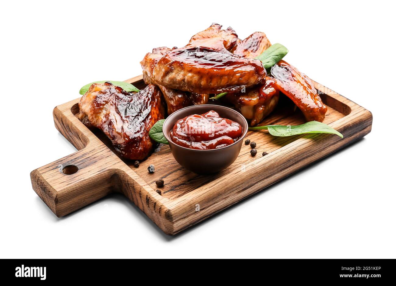 Board with roasted chicken wings and sauce on white background Stock ...