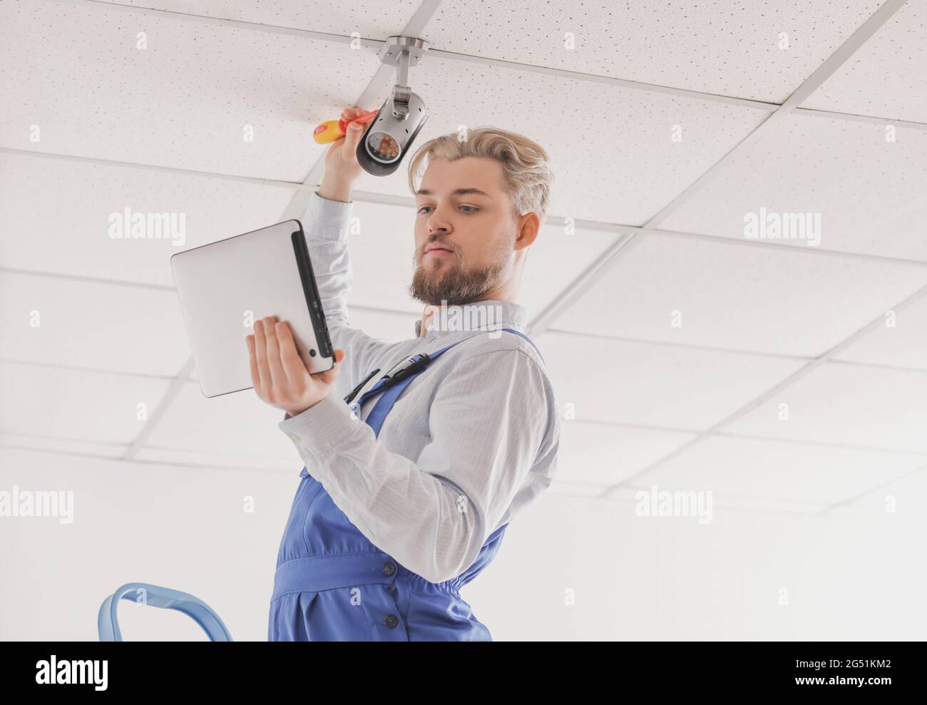Worker installing alarm system indoors Stock Photo - Alamy