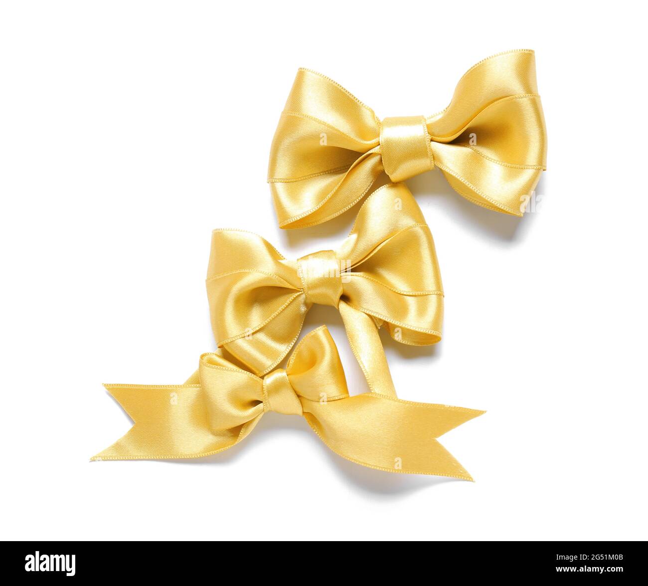 Beautiful golden bows on white background Stock Photo - Alamy