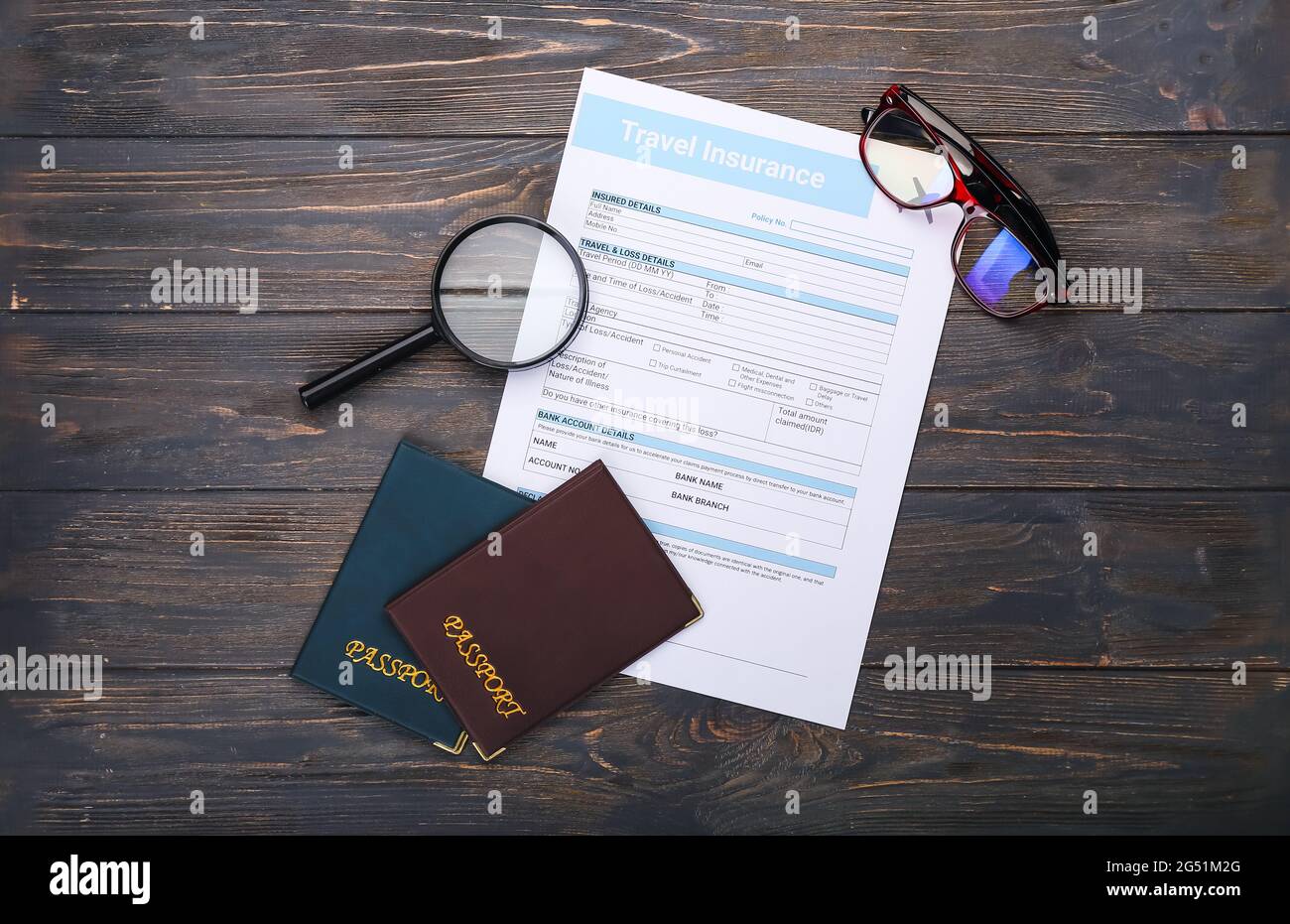 Composition with travel insurance and passports on dark wooden ...