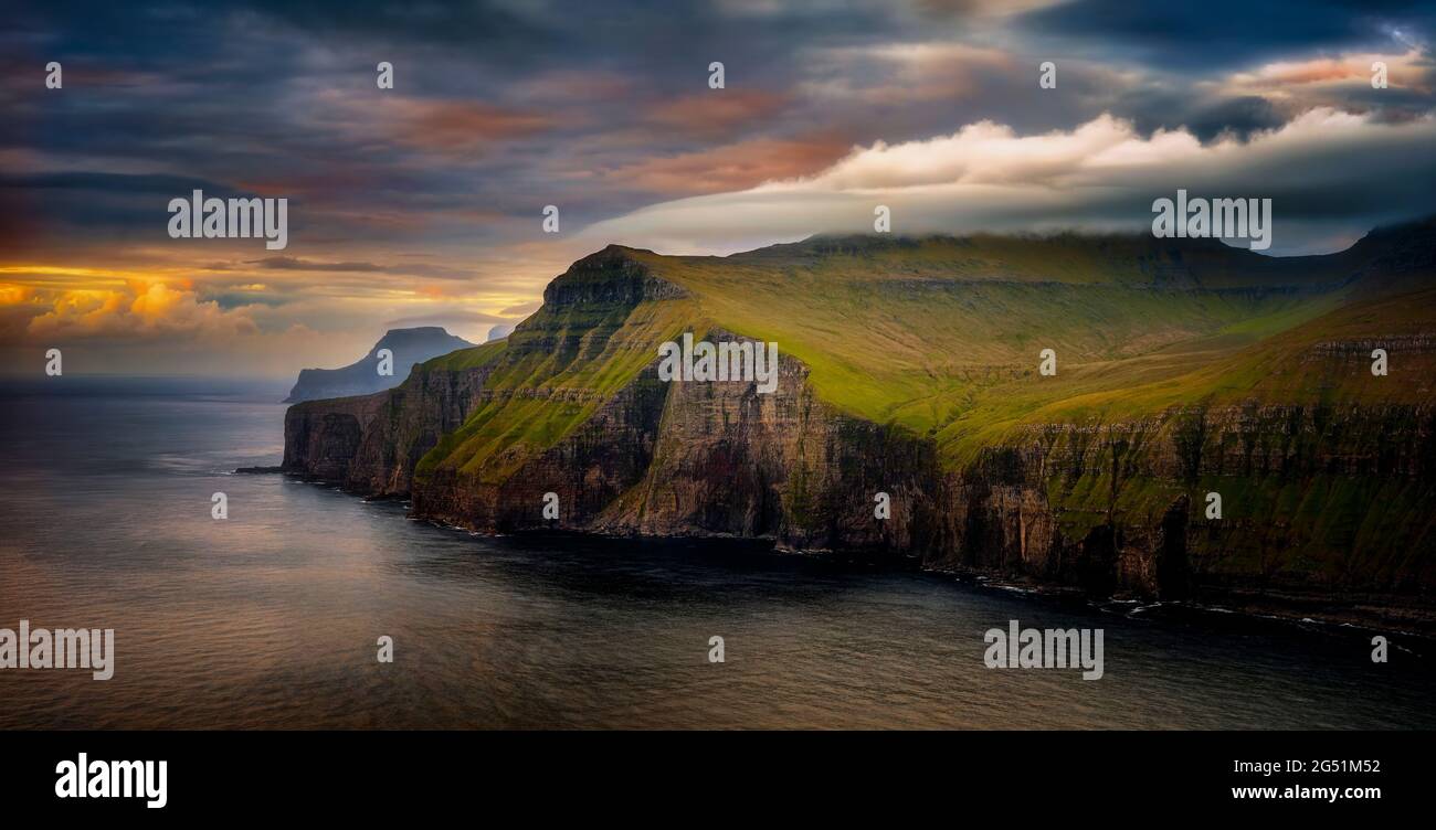 Landscape with coastal cliffs at sunset, Eysturoy, Faroe Islands ...